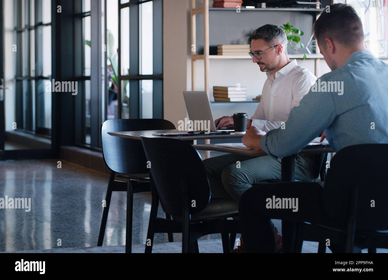 Work hard today for the success of tomorrow. two businessmen using ...