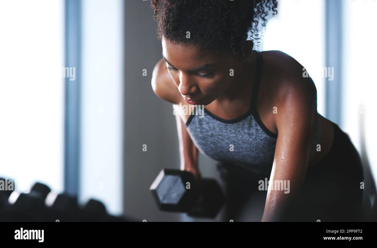 Improving her muscle strength and tone. a sporty young woman exercising ...