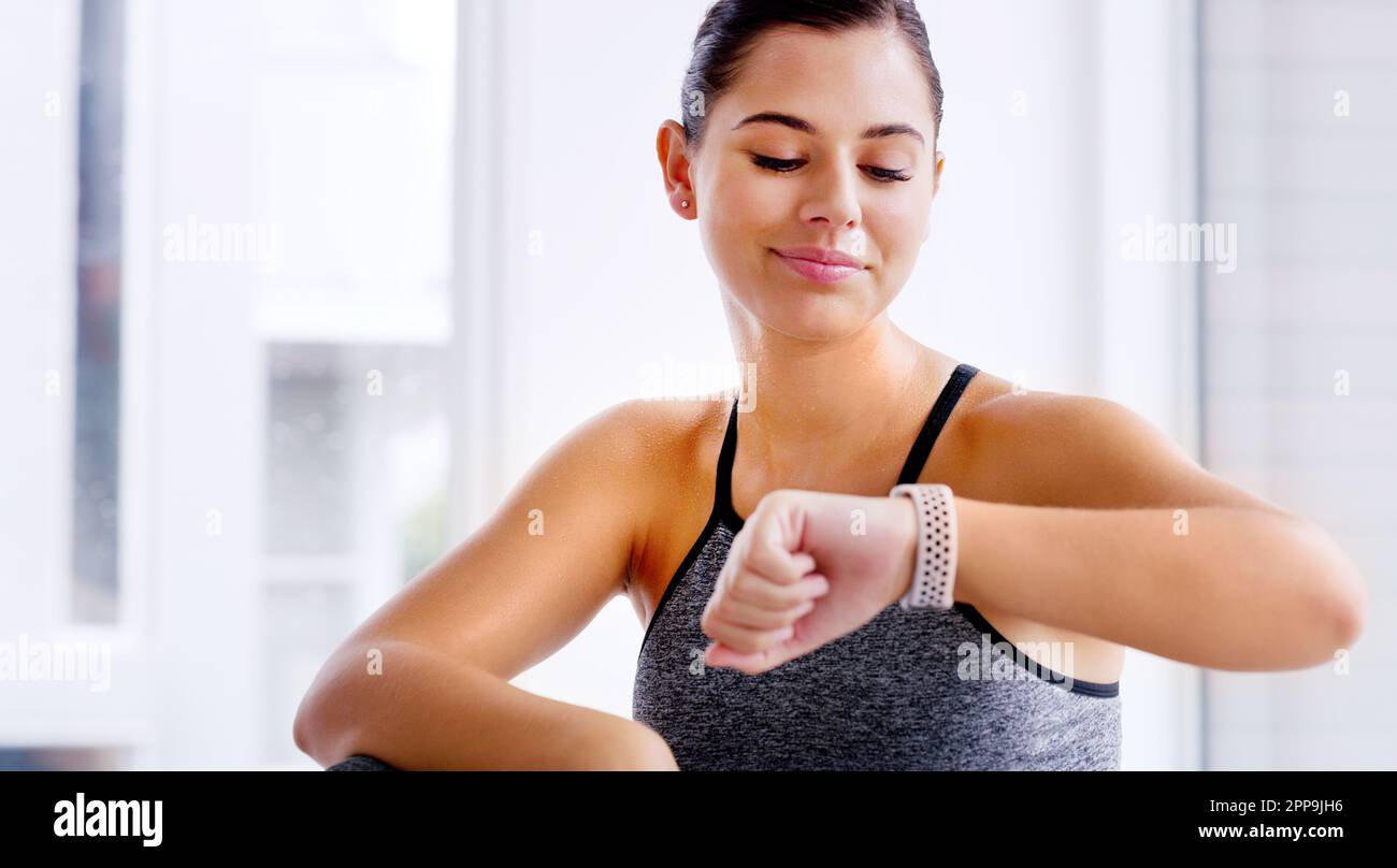 Beating the clock is what I do best. an attractive young woman checking ...