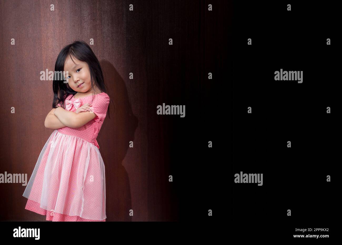 Portrait of a little Asian kid girl with arms crossed acting Stock ...