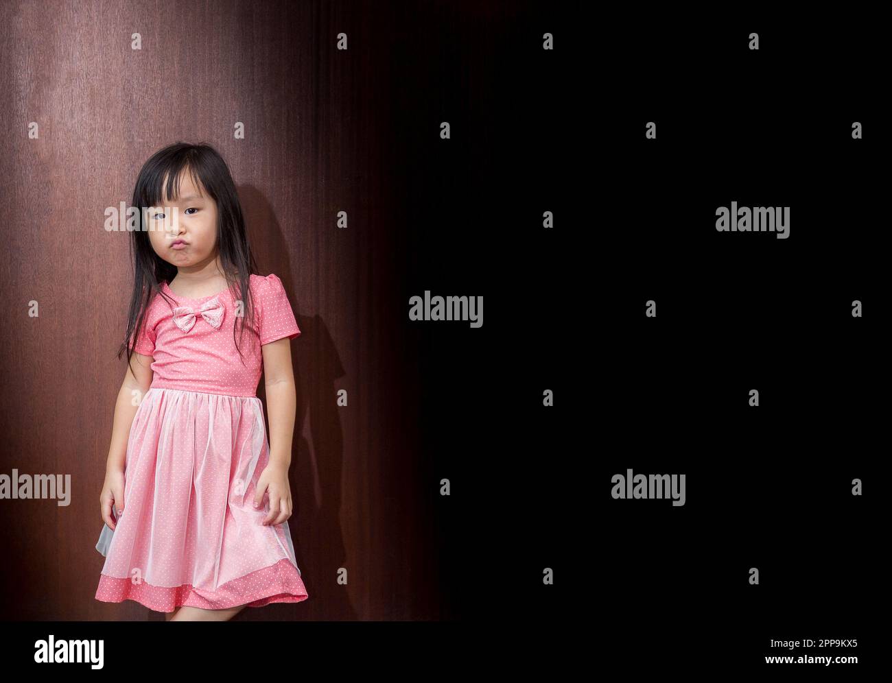 Portrait of a little Asian kid girl , Made to shorten mouth Stock Photo ...