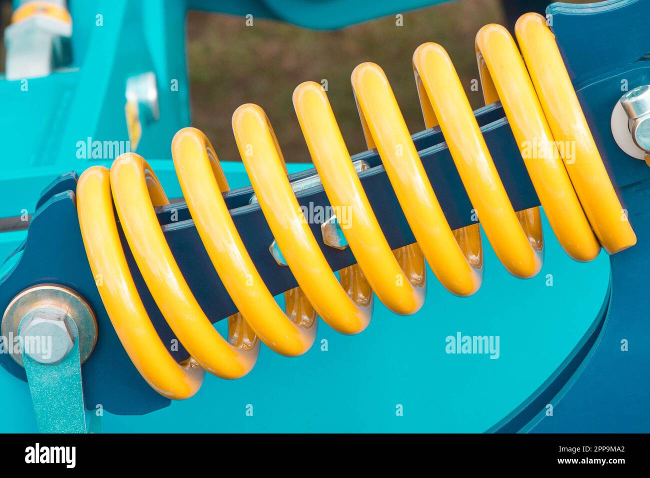 Hard spring made of steel. Part and detail of blue industrial or ...