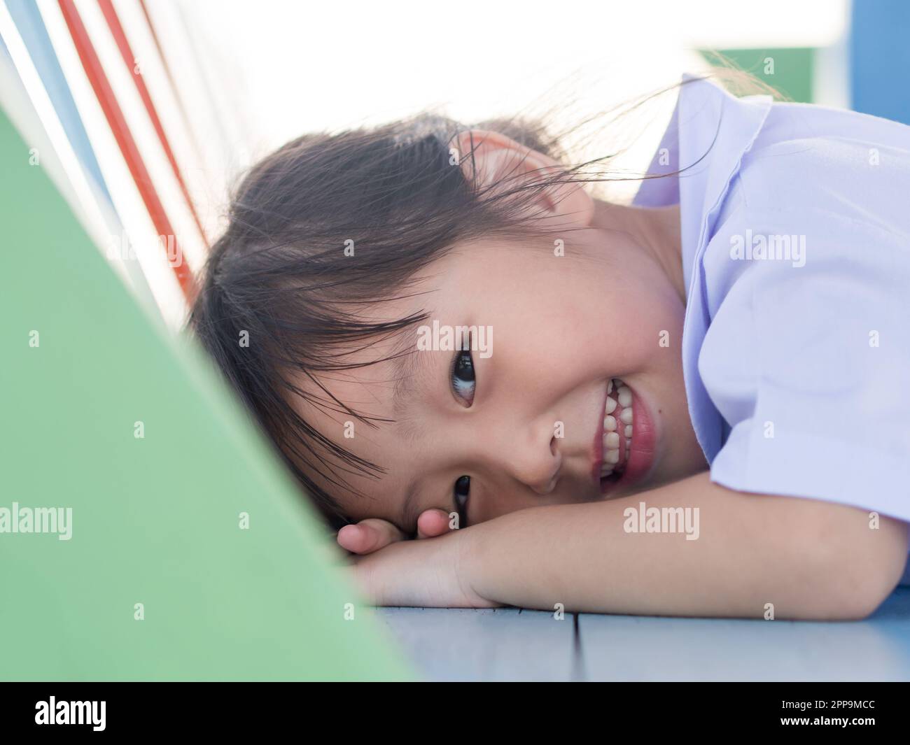Portrait of Asian happy little girl , fall down on the table, vintage ...