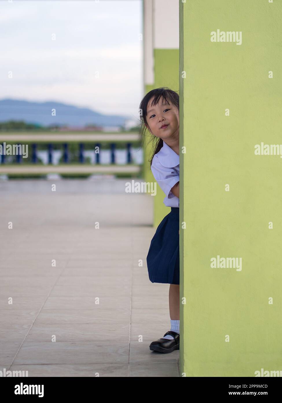 Adorable little girl playing peekaboo, asian child Stock Photo - Alamy