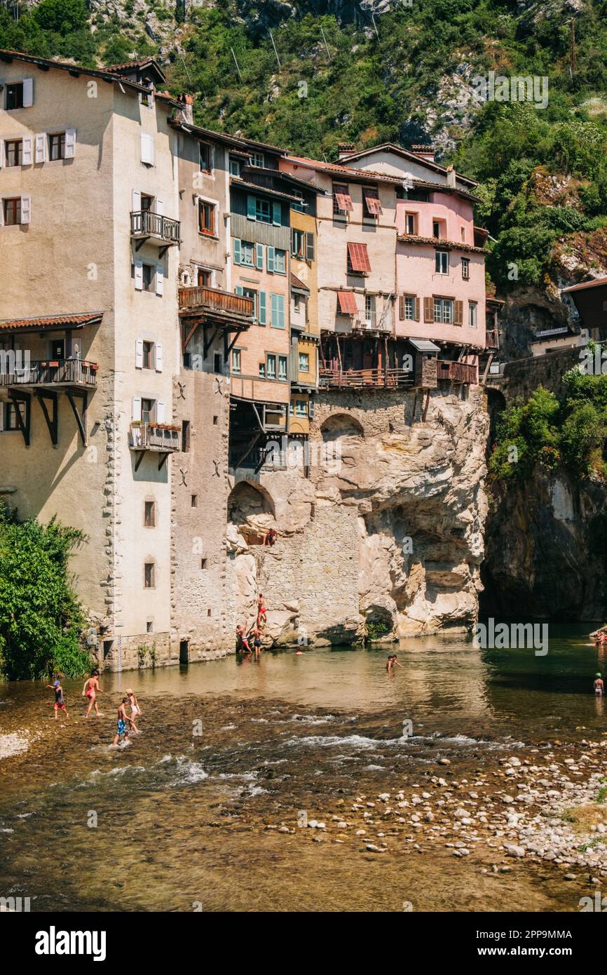 The Pont-en-Royans village with its hanging houses and the blue waters ...