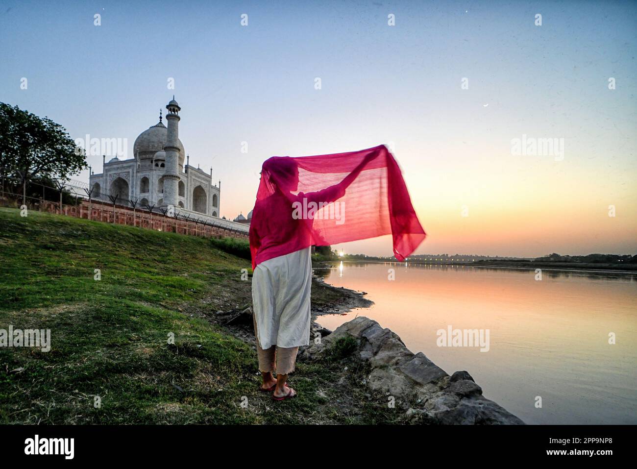 Agra, India. 22nd Apr, 2023. A woman poses for a photo behind the ...