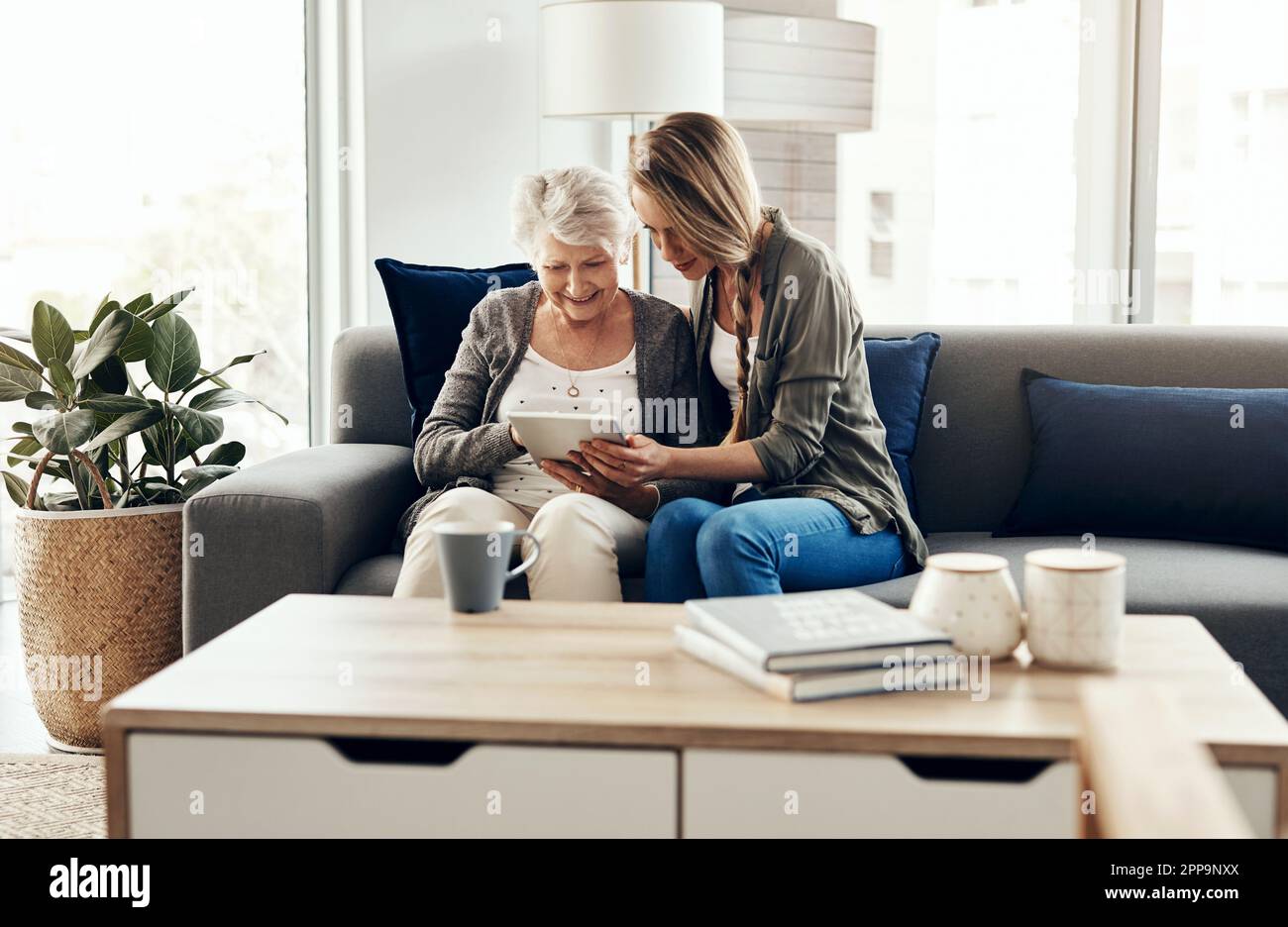 Showing mom how to use social media. a senior woman and her daughter ...