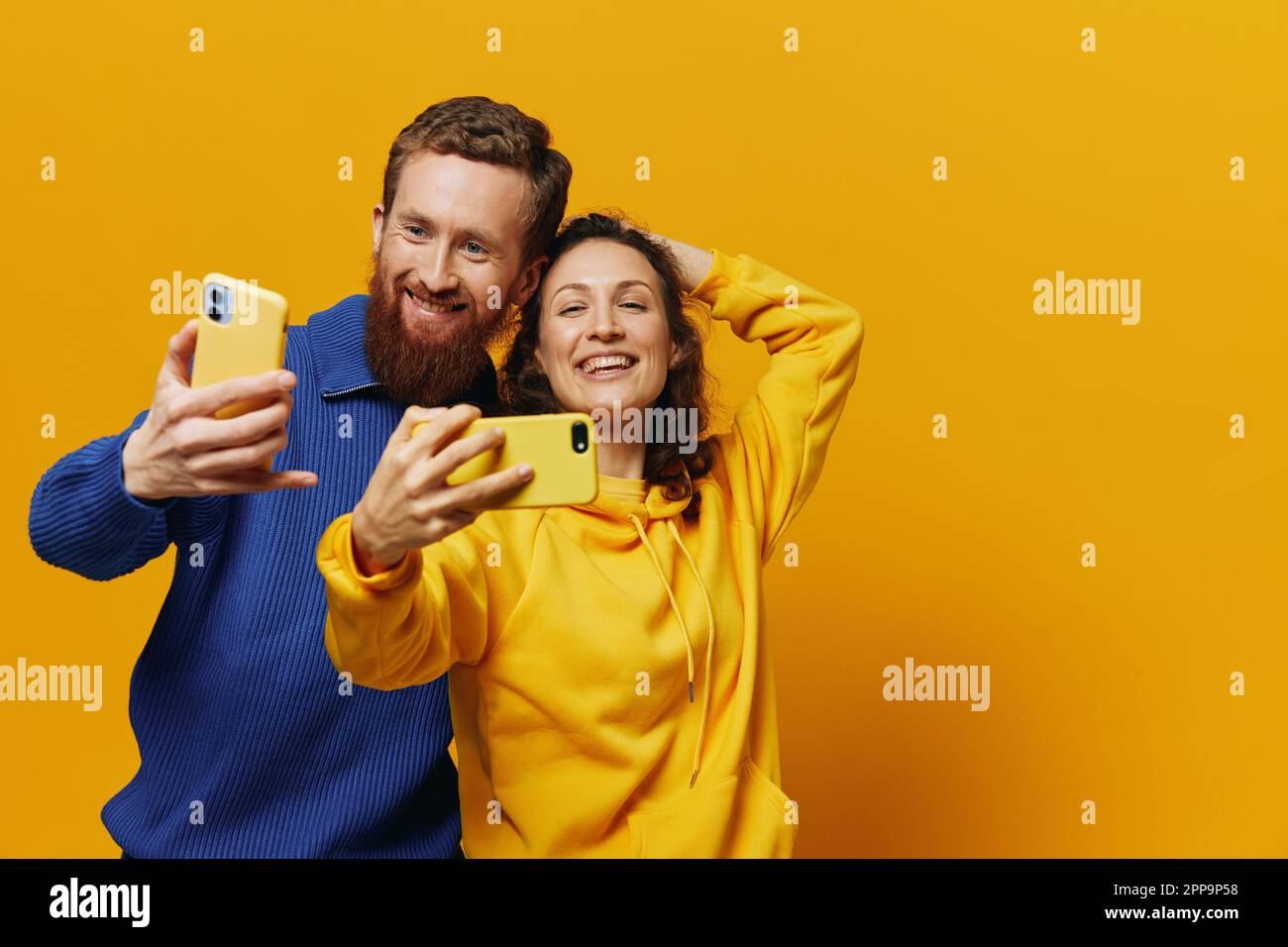 Man and woman couple smiling merrily with phone in hand social media ...