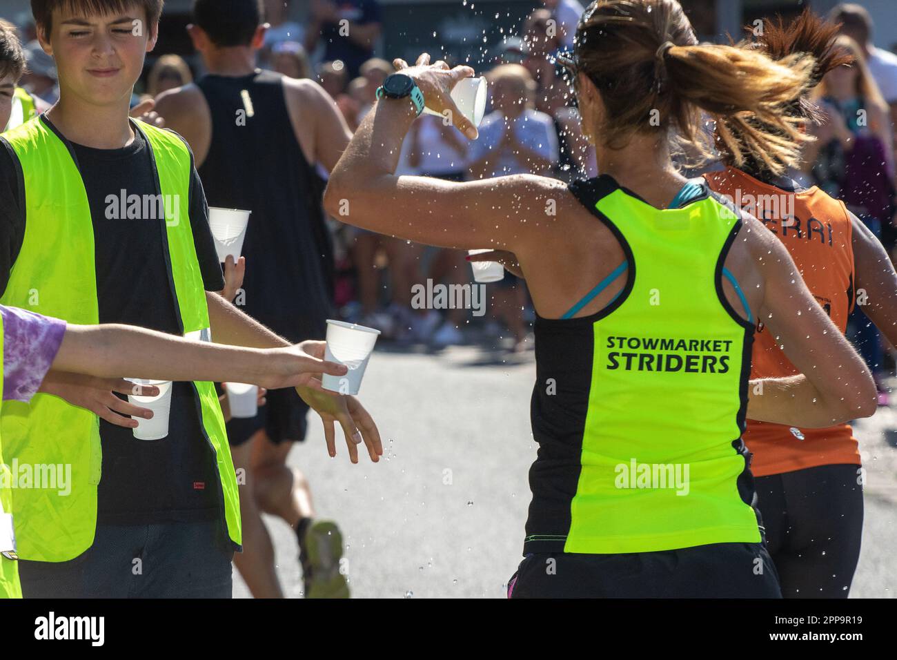 Runner in the Framlingham Flyers' 10k road race uses a handed up ...