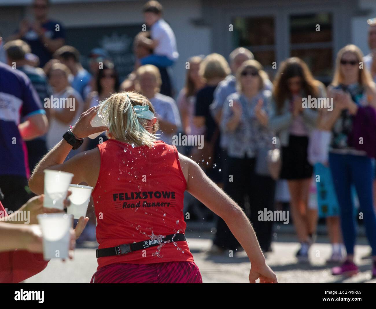 Runner in the Framlingham Flyers' 10k road race uses a handed up ...