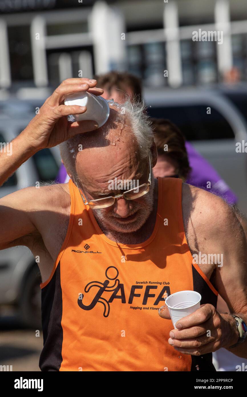 Runner in the Framlingham Flyers' 10k road race uses a handed up ...