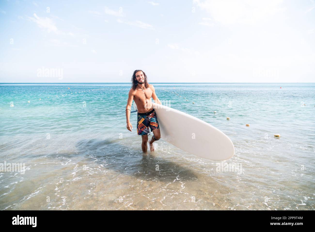 Sea man sup. Asian athlete man swimming in sea and paddleboarding at ...