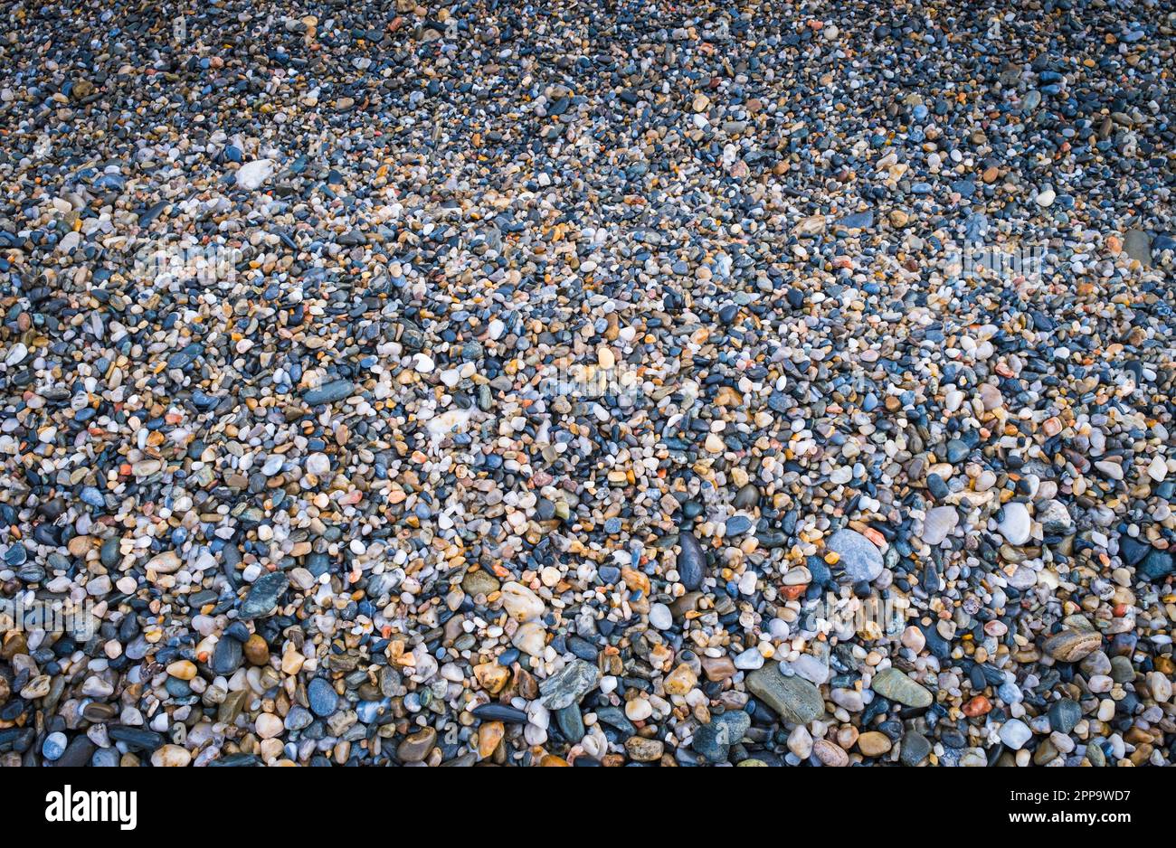 Close-up of the Smooth and Rounded Pebbles Texture on Sandy Beach ...