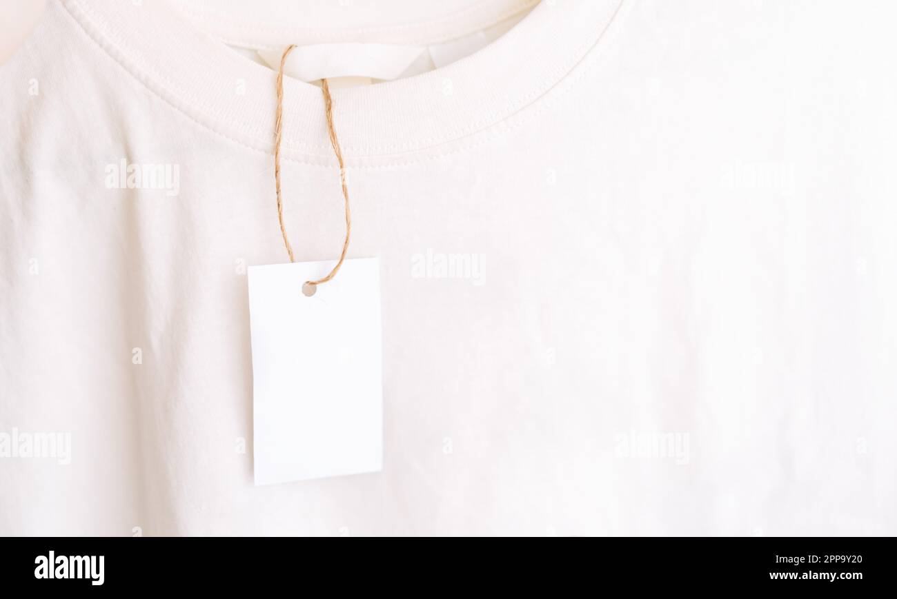 White t-shirt with an empty tag without inscriptions Stock Photo - Alamy