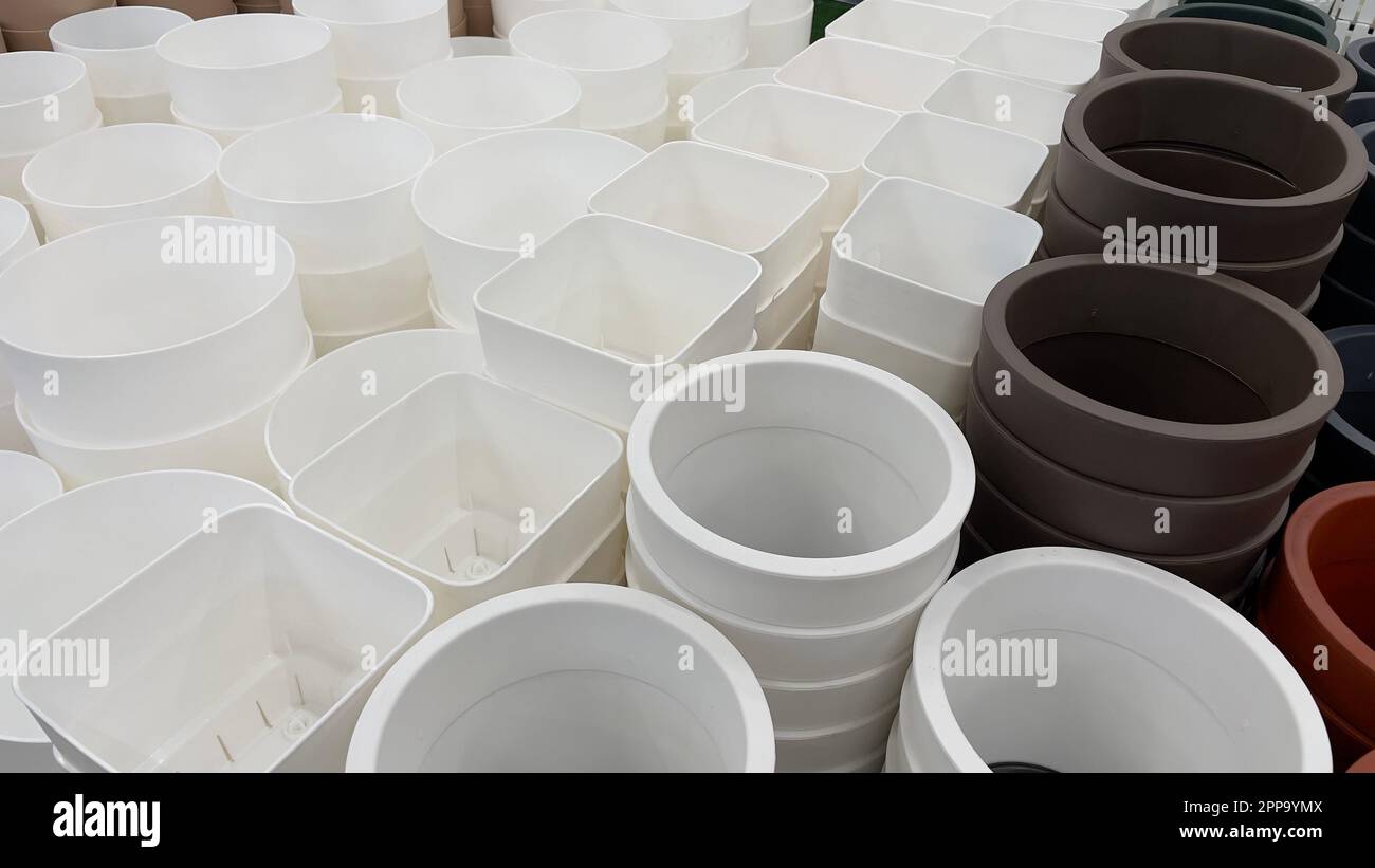 Close-up of empty flower pots in a store or greenhouse. Colorful pots ...