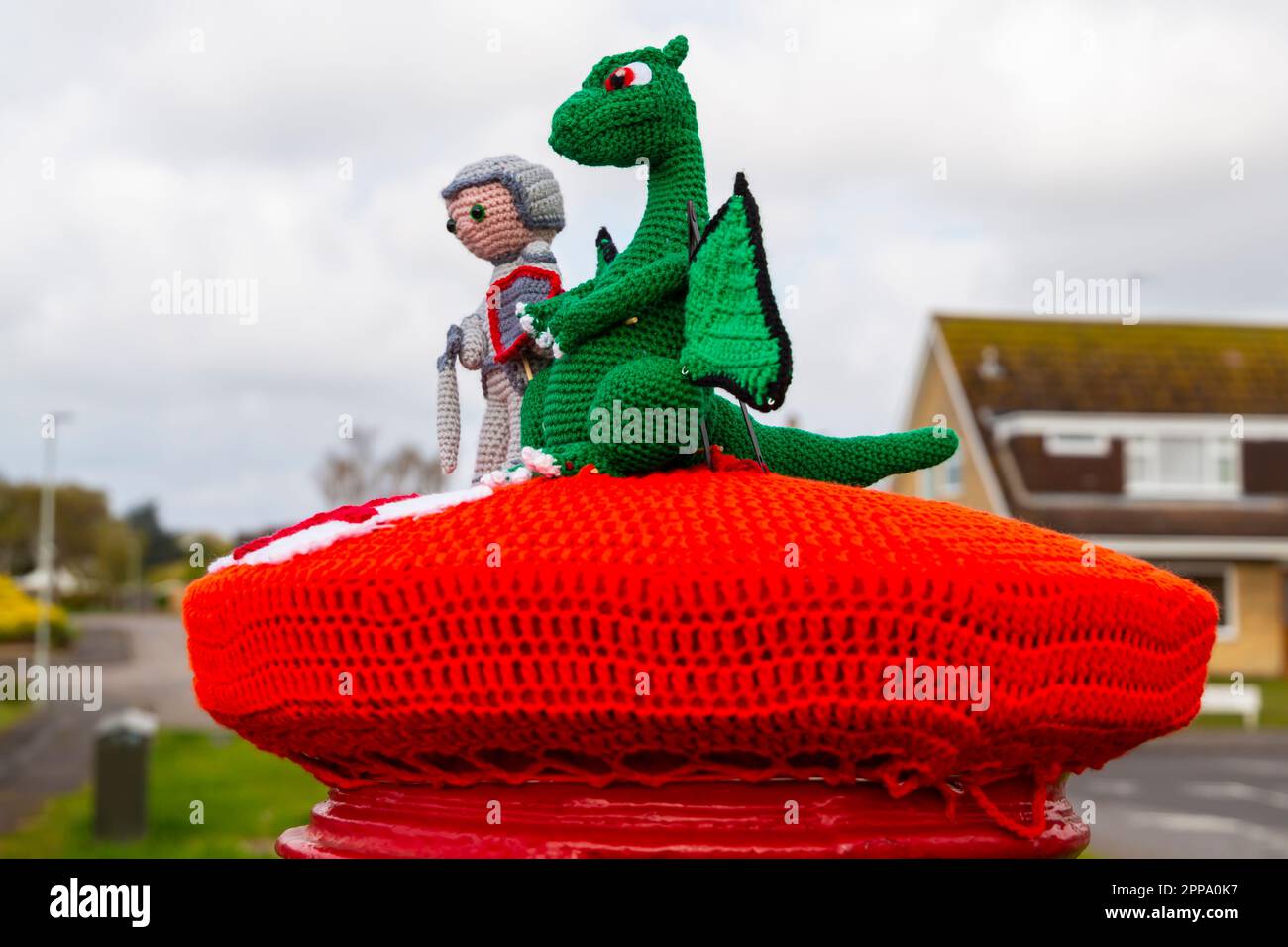 Poole, Dorset, UK. 23rd April 2023. A knitted crocheted postbox topper ...