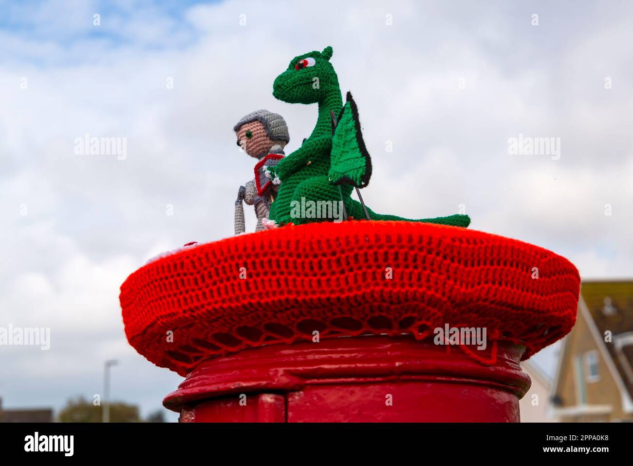 Poole, Dorset, UK. 23rd April 2023. A knitted crocheted postbox topper ...