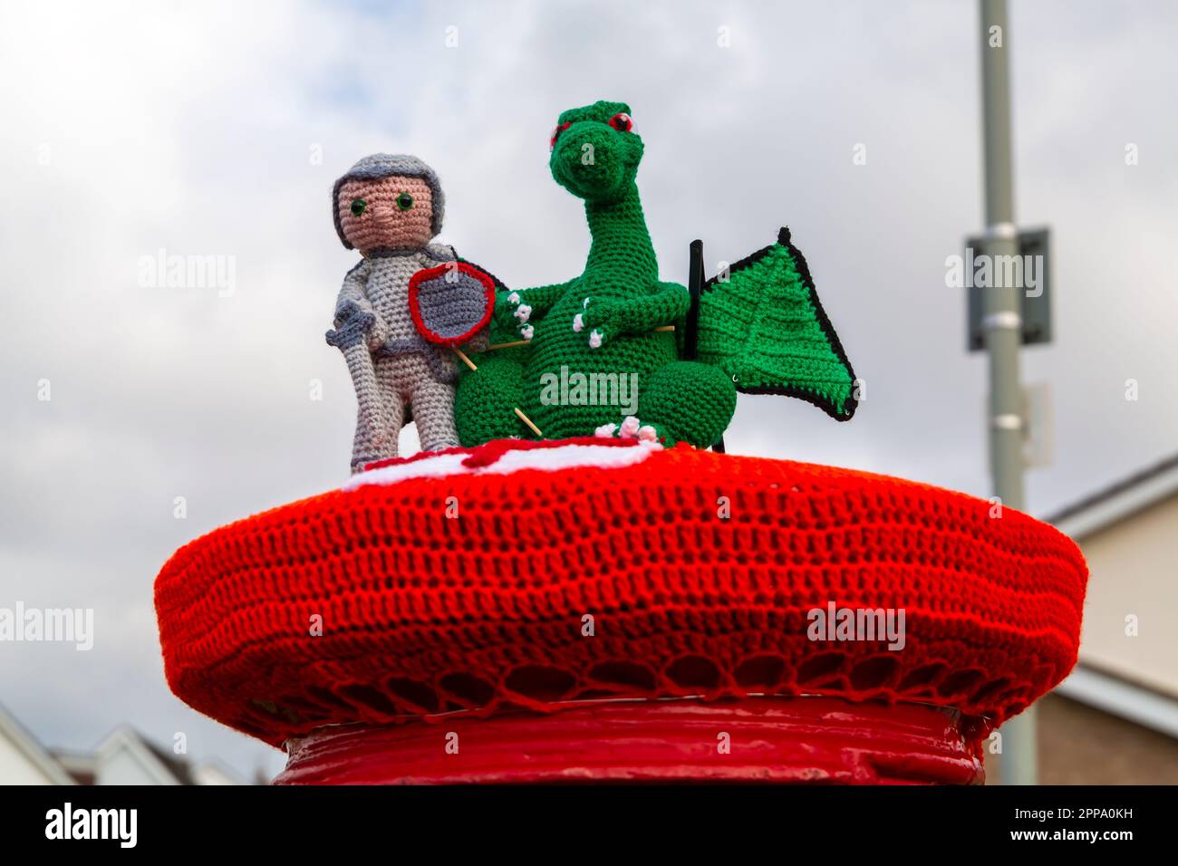 Poole, Dorset, UK. 23rd April 2023. A knitted crocheted postbox topper ...