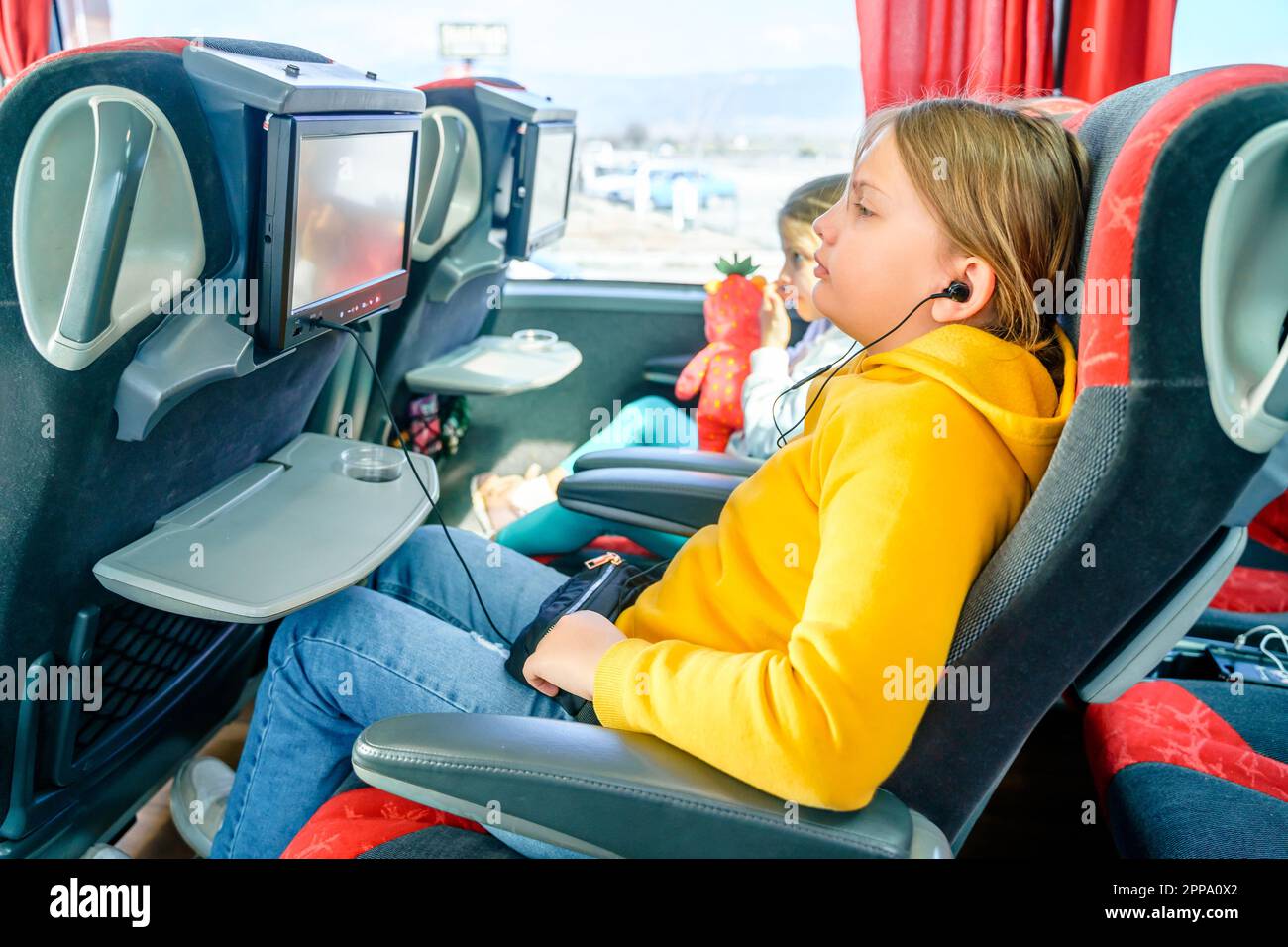 Bus road traveling. Girl kid rides on large comfortable sightseeing ...
