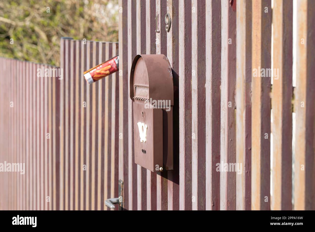 Newspaper sandwiched between the fence rails hi-res stock photography ...