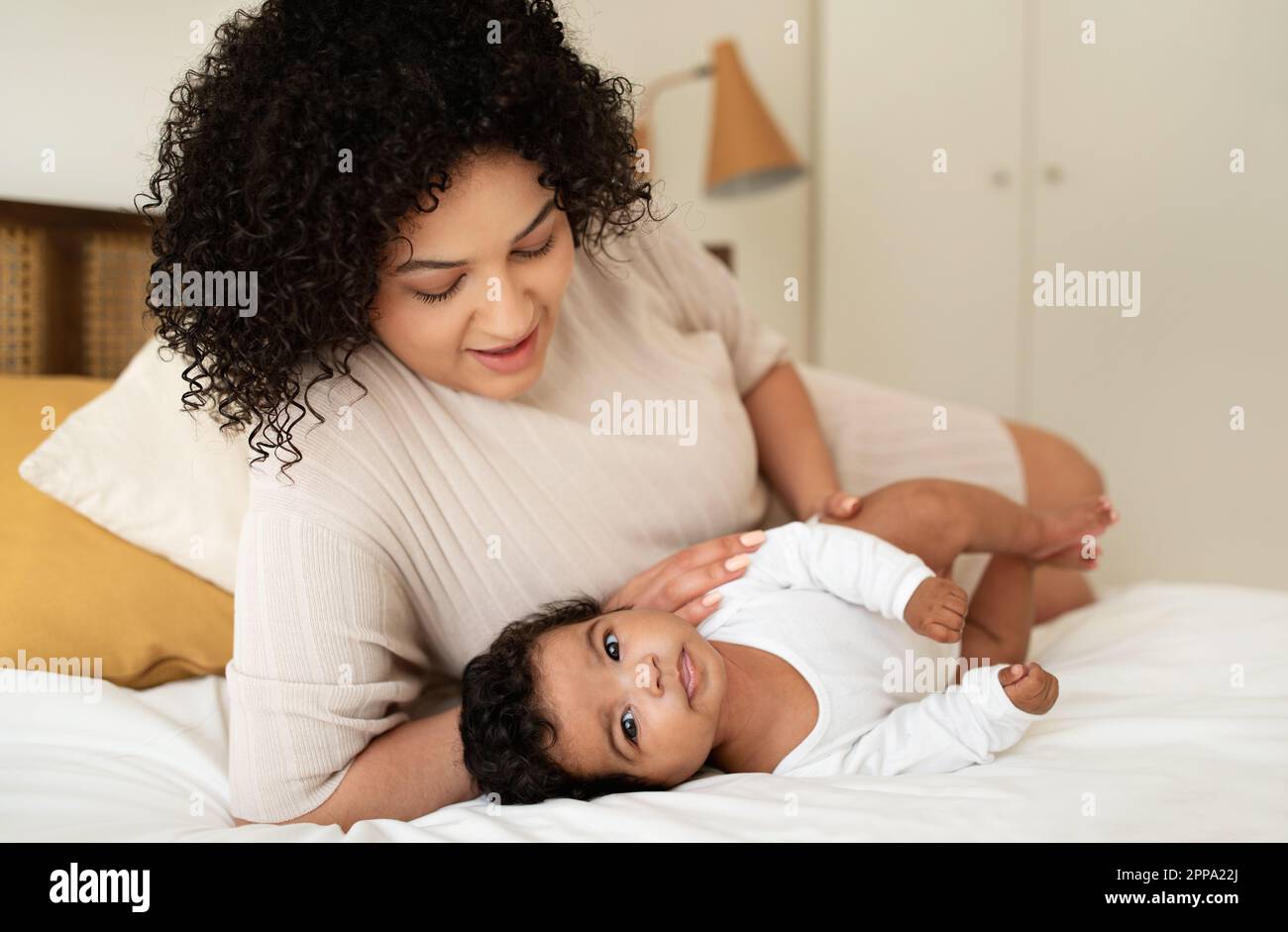 Baby care, parenthood and motherhood. Smiling young african american ...