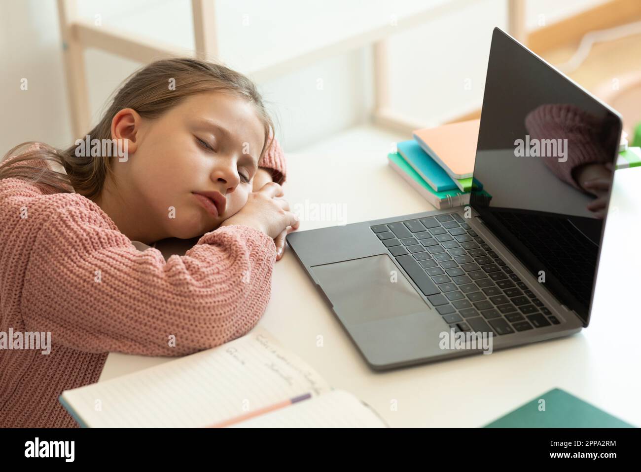 Sad tired european teenager girl doing homework, sleeping near computer ...