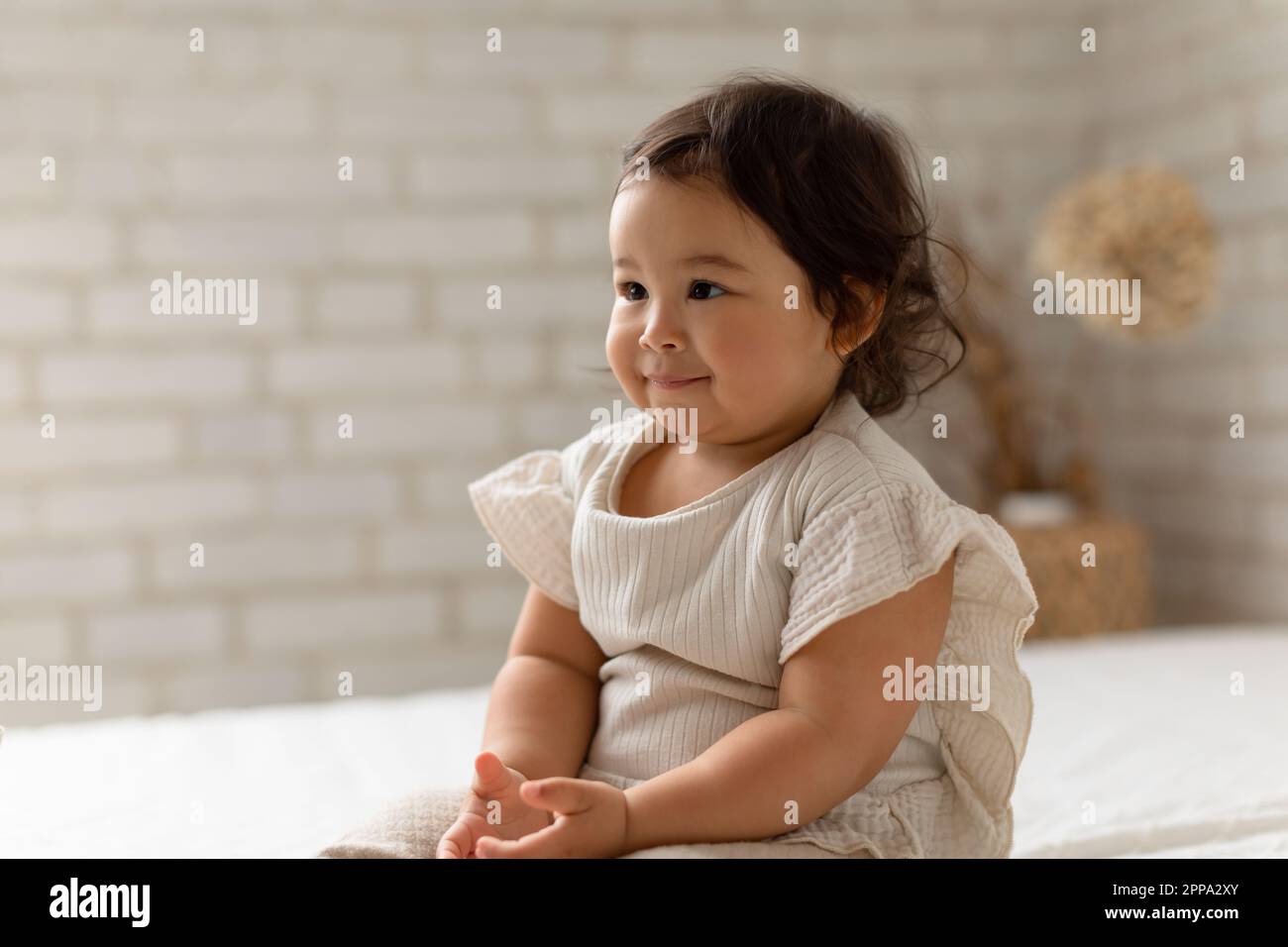 Portrait Of Cute Asian Baby Girl Sitting Looking Aside Indoor Stock Photo - Alamy