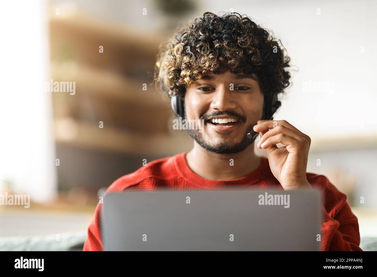 Telecommuting Concept. Young Indian Male Wearing Headset Working On ...