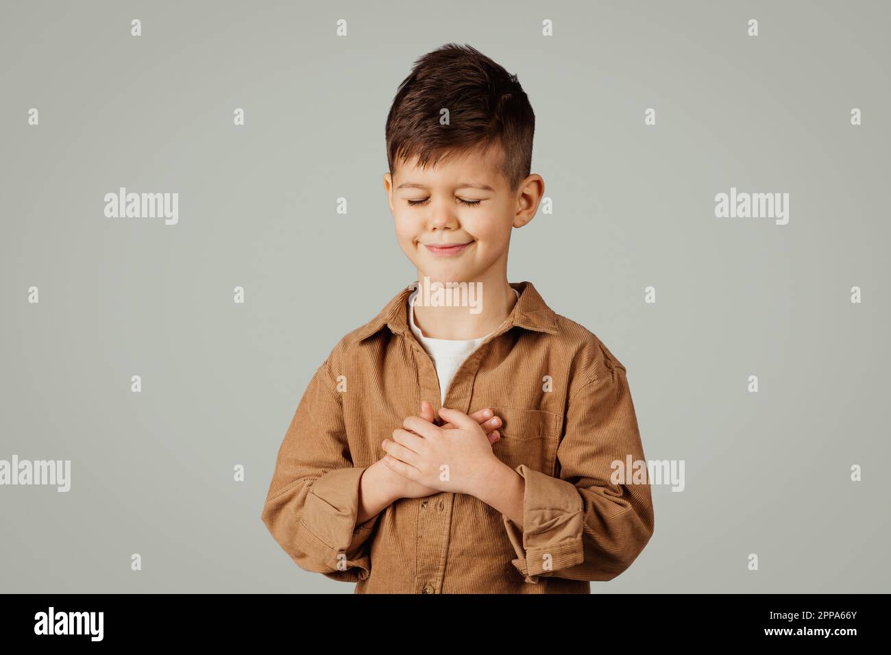 Positive cute little european child 6 years old in casual with closed ...