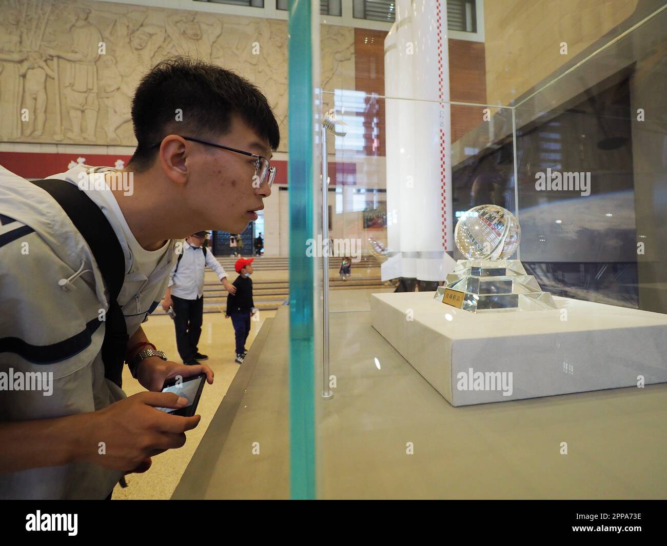 BEIJING, CHINA - APRIL 23, 2023 - A visitor looks at a "lunar sample ...