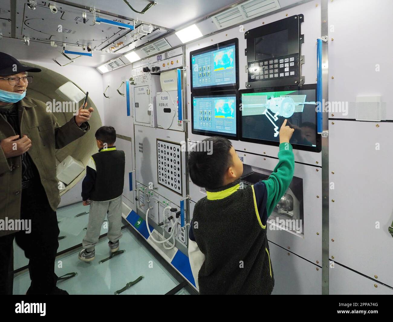 BEIJING, CHINA - APRIL 23, 2023 - Visitors look inside a model of the ...