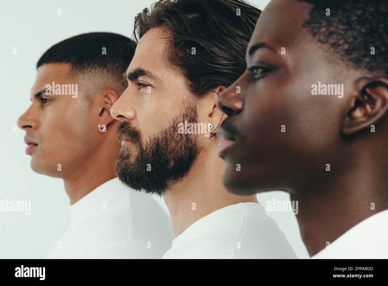 Three men standing in a studio, confident and proud of their flawless ...