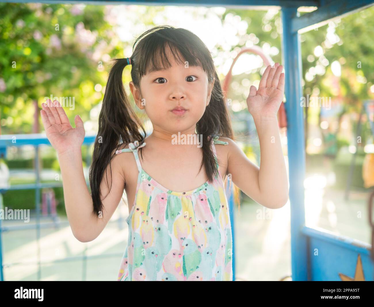 asian baby child playing on playground, in sunset light, peekaboo action Stock Photo - Alamy