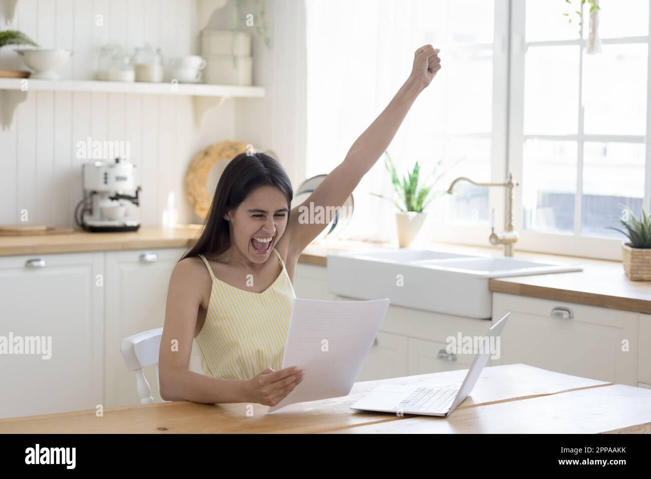 Happy excited girl throwing fist up in winner hand gesture Stock Photo ...
