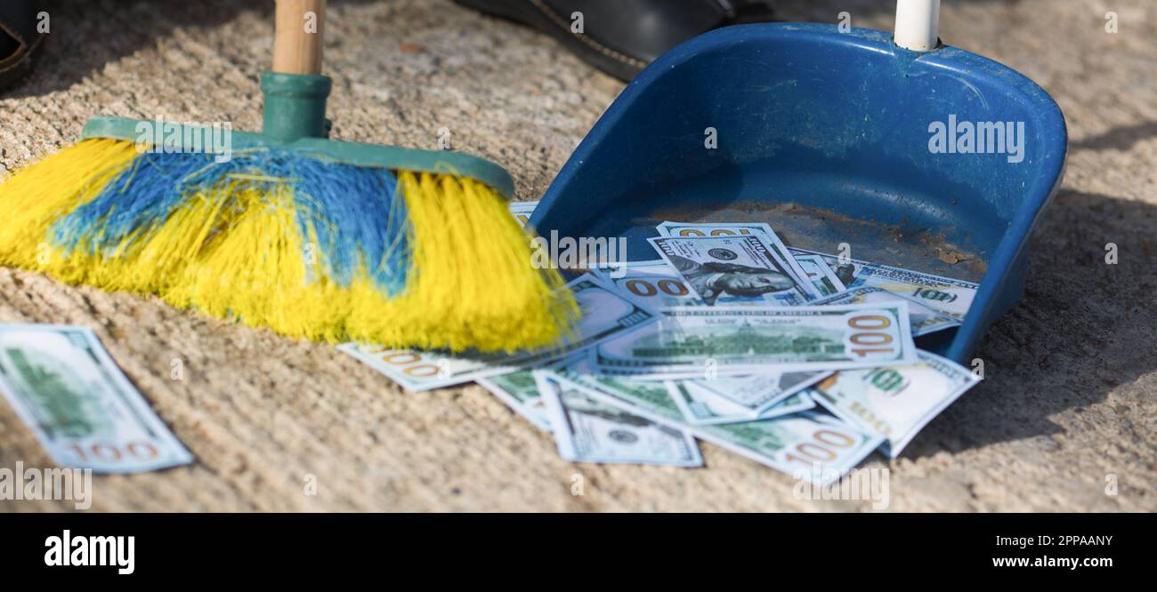 Man sweeping paper dollars from the ground, hyperinflation concept ...