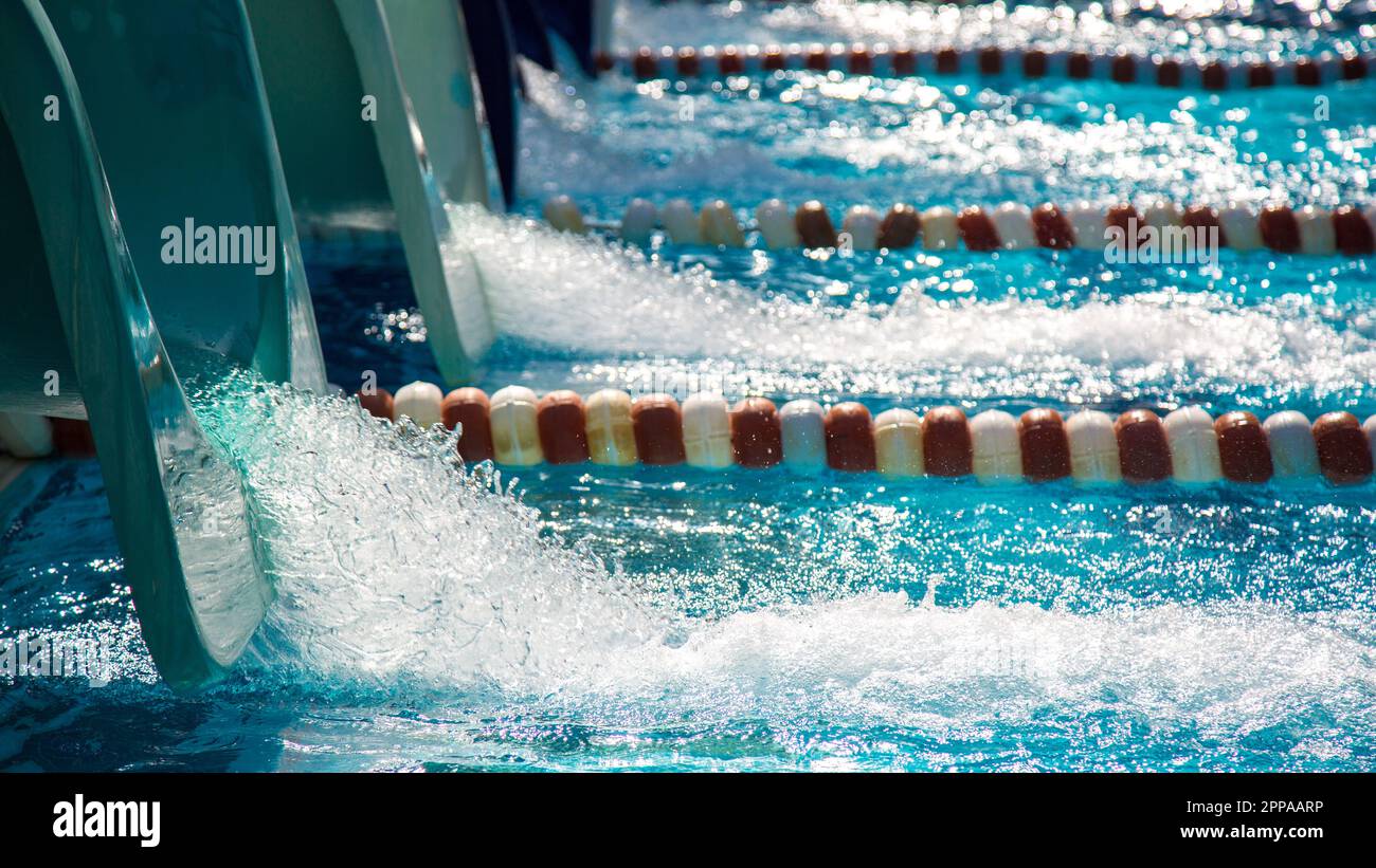 Stream of clear blue water from a pipe water park Stock Photo - Alamy