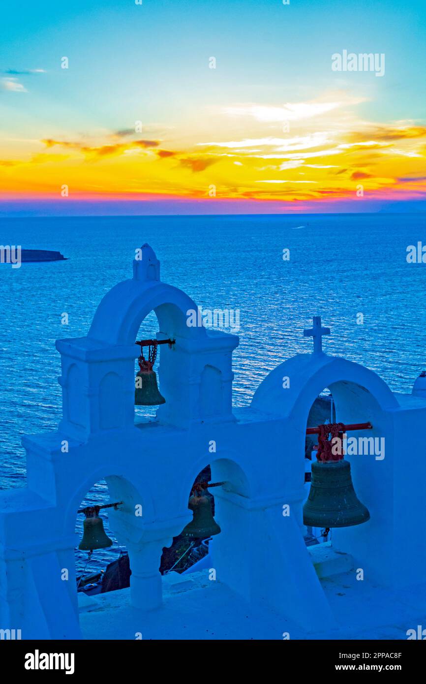 The belfry of Saint Ekaterini Oia Holy Orthodox Church against sunset ...