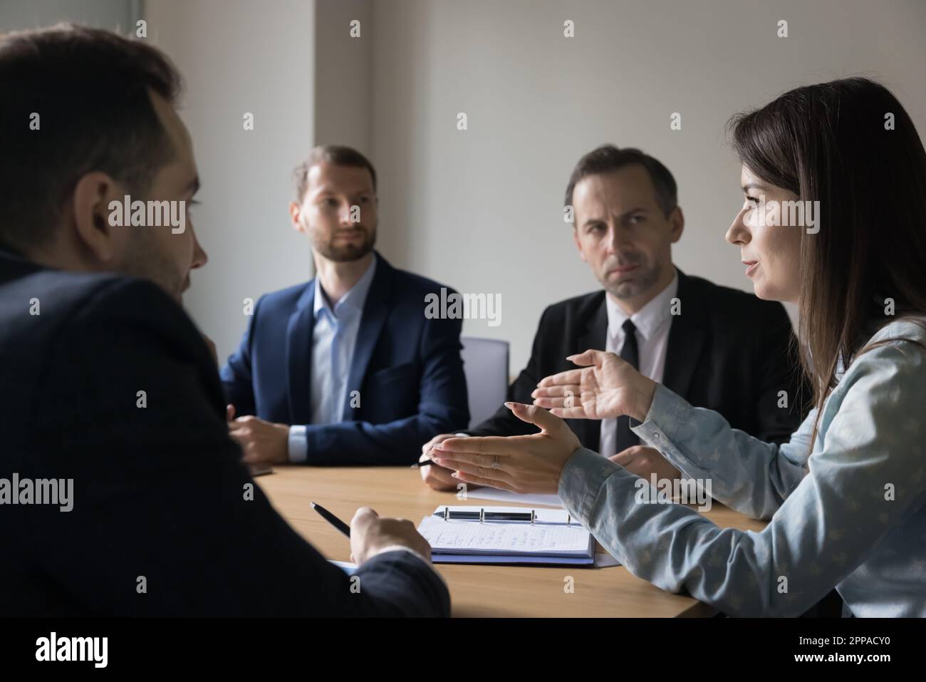 Confident female CEO speaking to coworkers on meeting Stock Photo - Alamy