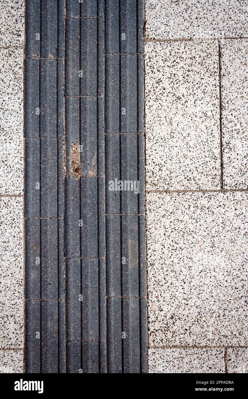 Textured walkway for blind people. Black tactile paving for the ...