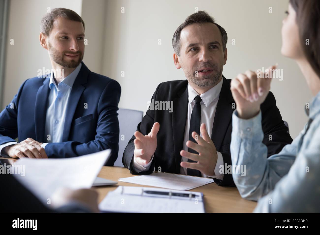 Engaged mature business leader man talking to younger colleague Stock ...