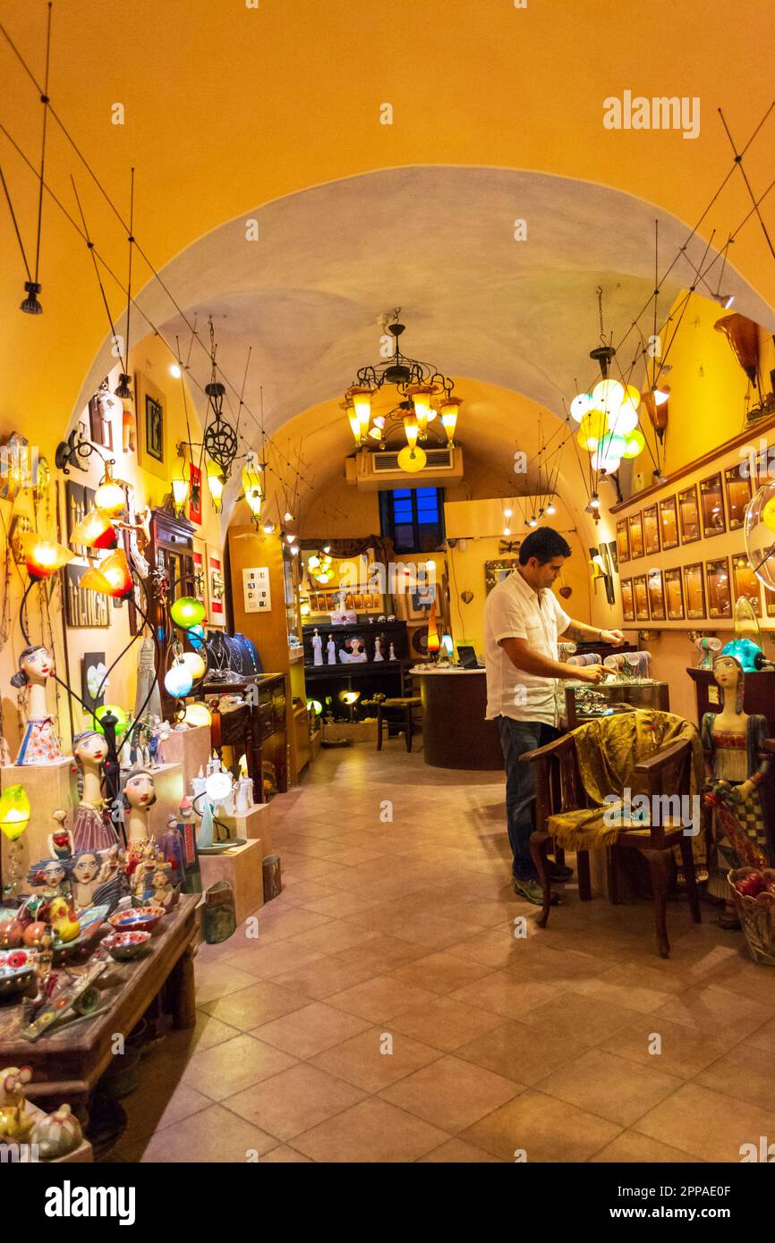 Picturesque traditional souvenir shop in cave house in Oia .Oia is a ...