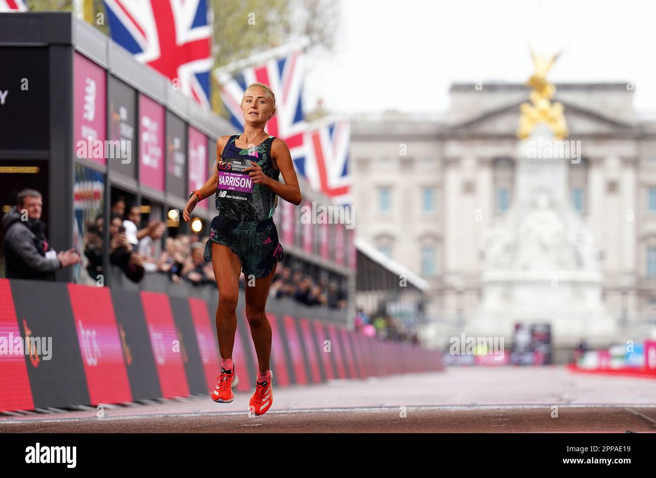 Sam Harrison crosse the finish line in the Women's elite race during the TCS London Marathon ...
