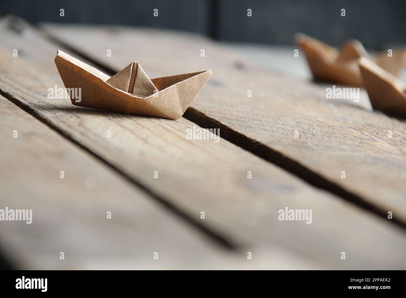 Paper boats on a vintage background. Origami paper boat Stock Photo - Alamy