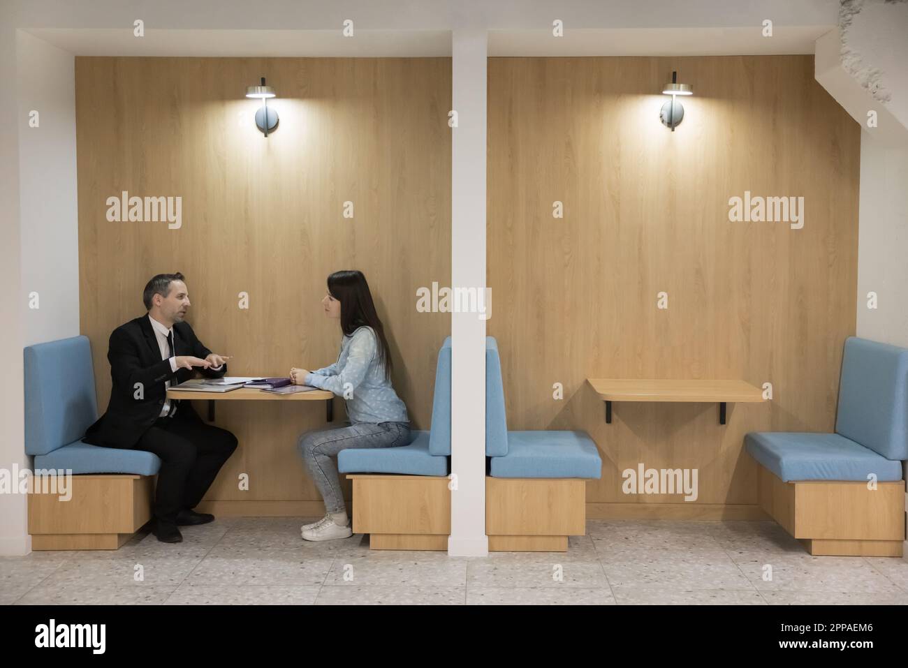 Young customer woman meeting with expert in office booth Stock Photo ...