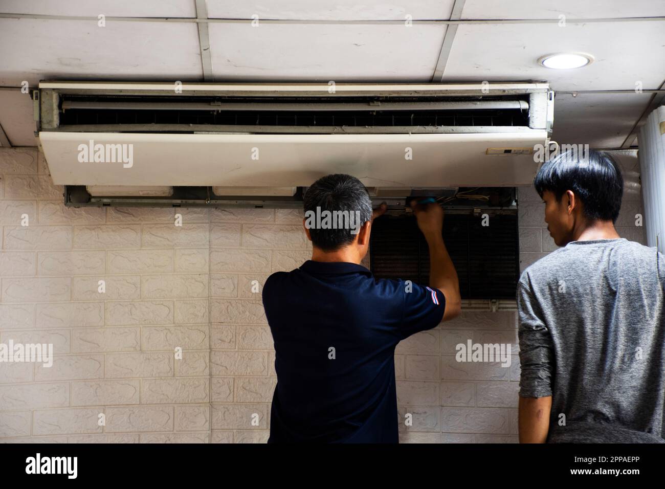 Thai mechanic and air conditioner technician professional working ...