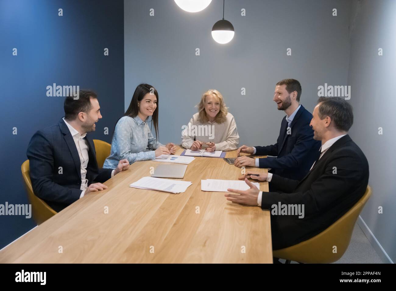 Positive happy coworkers having fun at table, talking, laughing Stock ...