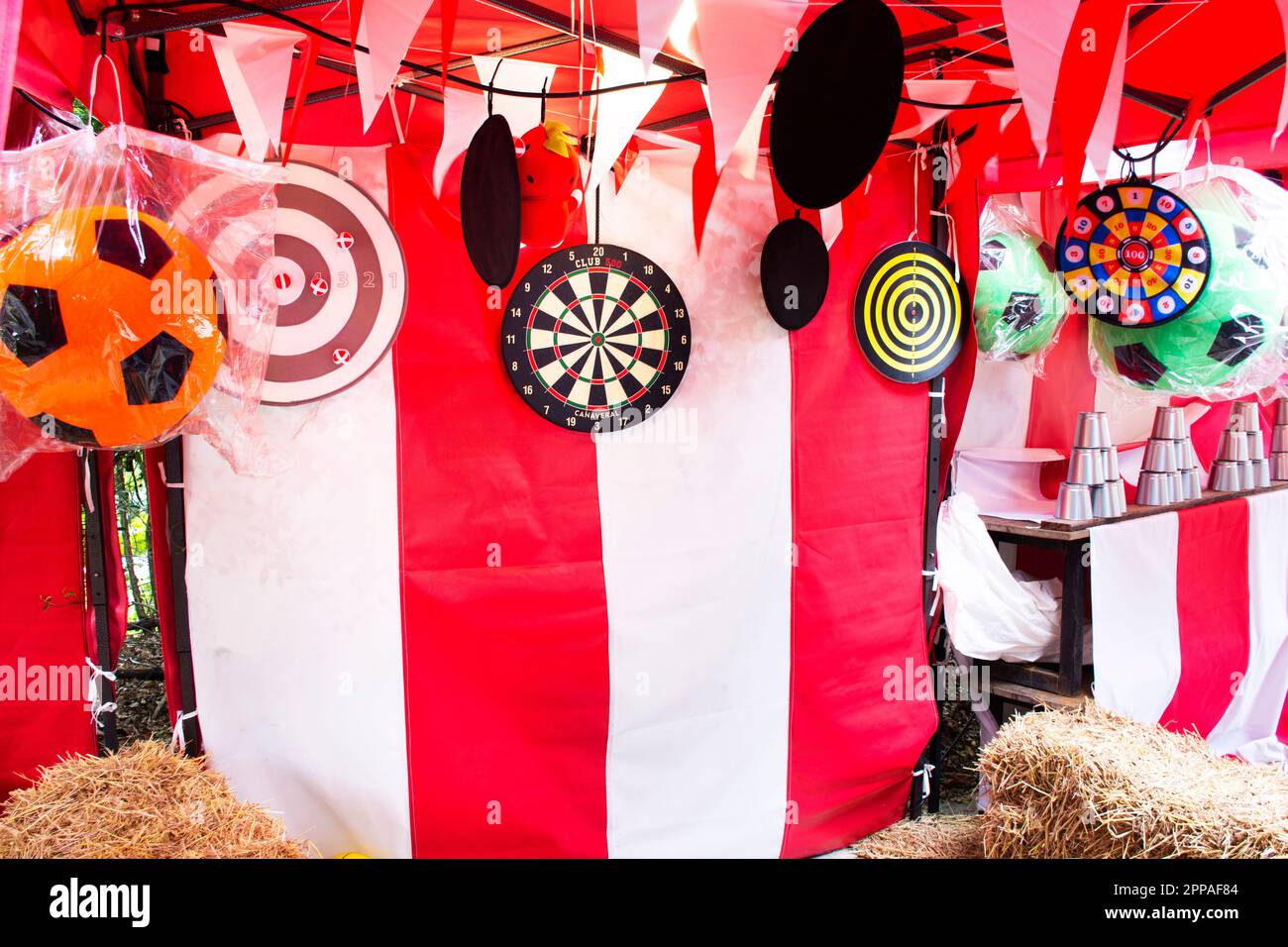 Darts throwing or throwers arrows in dartboard local carnival funfair ...
