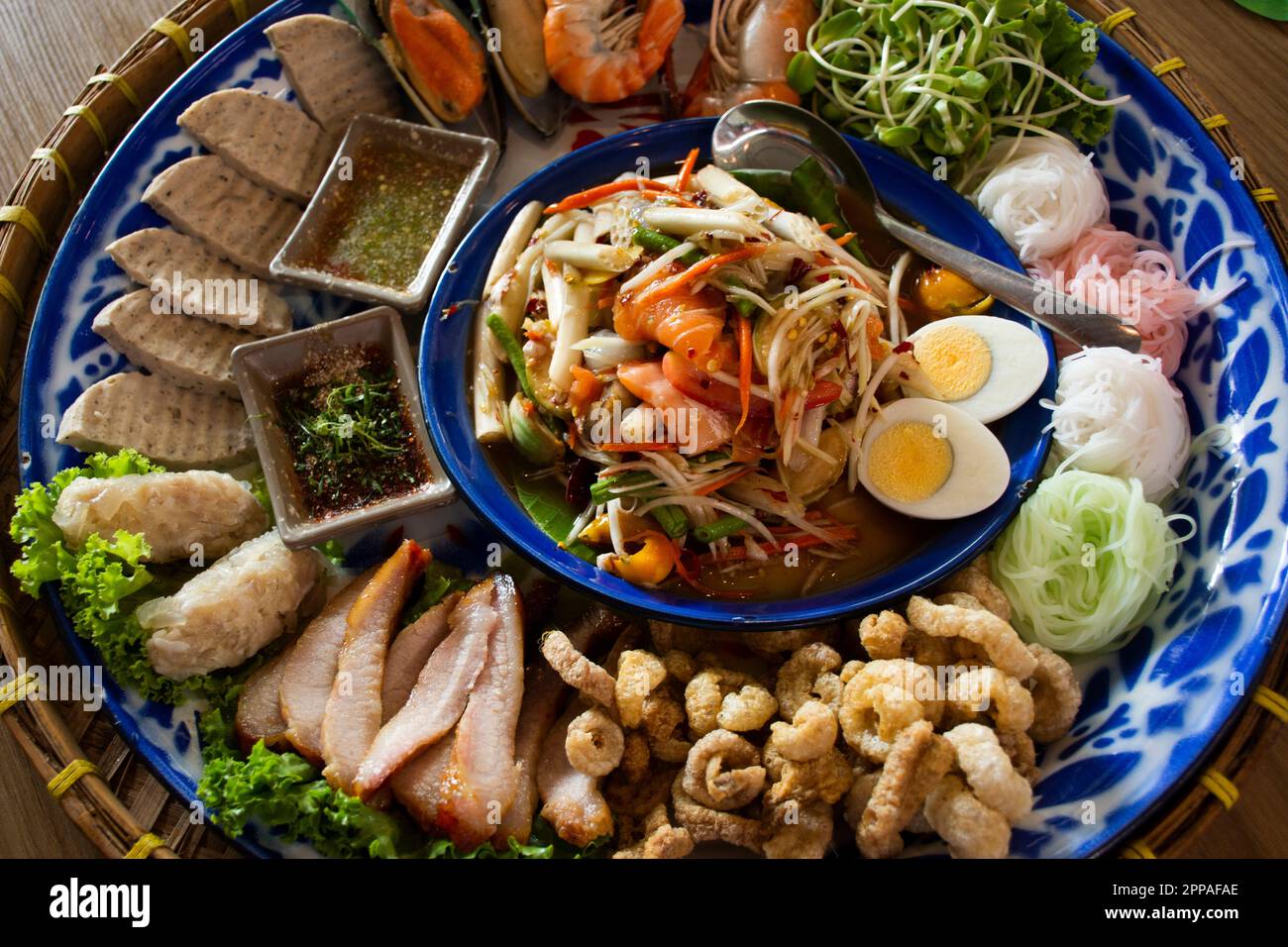 Traditional thai food local gourmet Som Tum or spicy green papaya salad ...