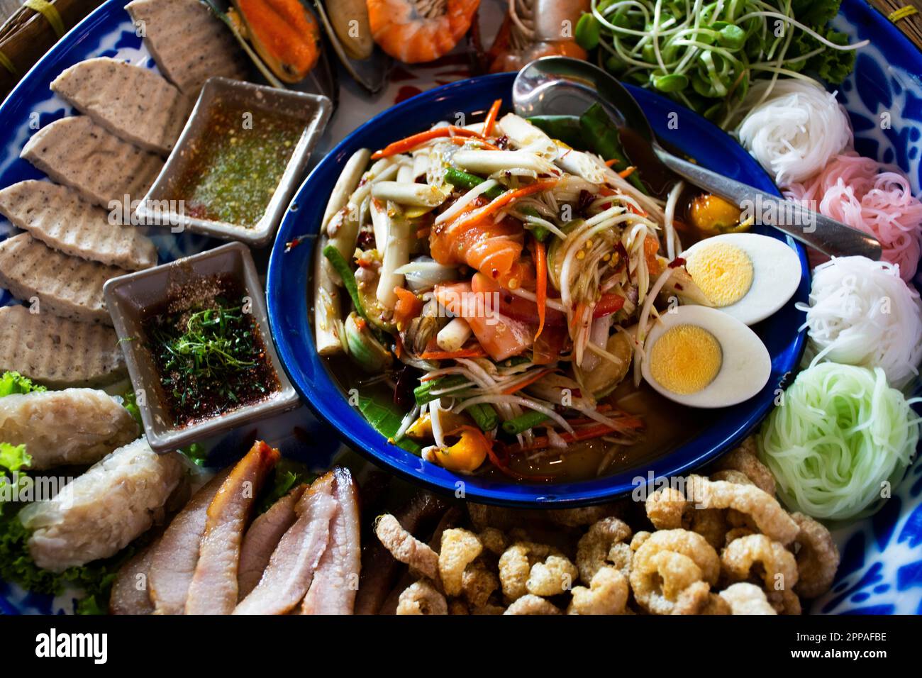 Traditional thai food local gourmet Som Tum or spicy green papaya salad ...