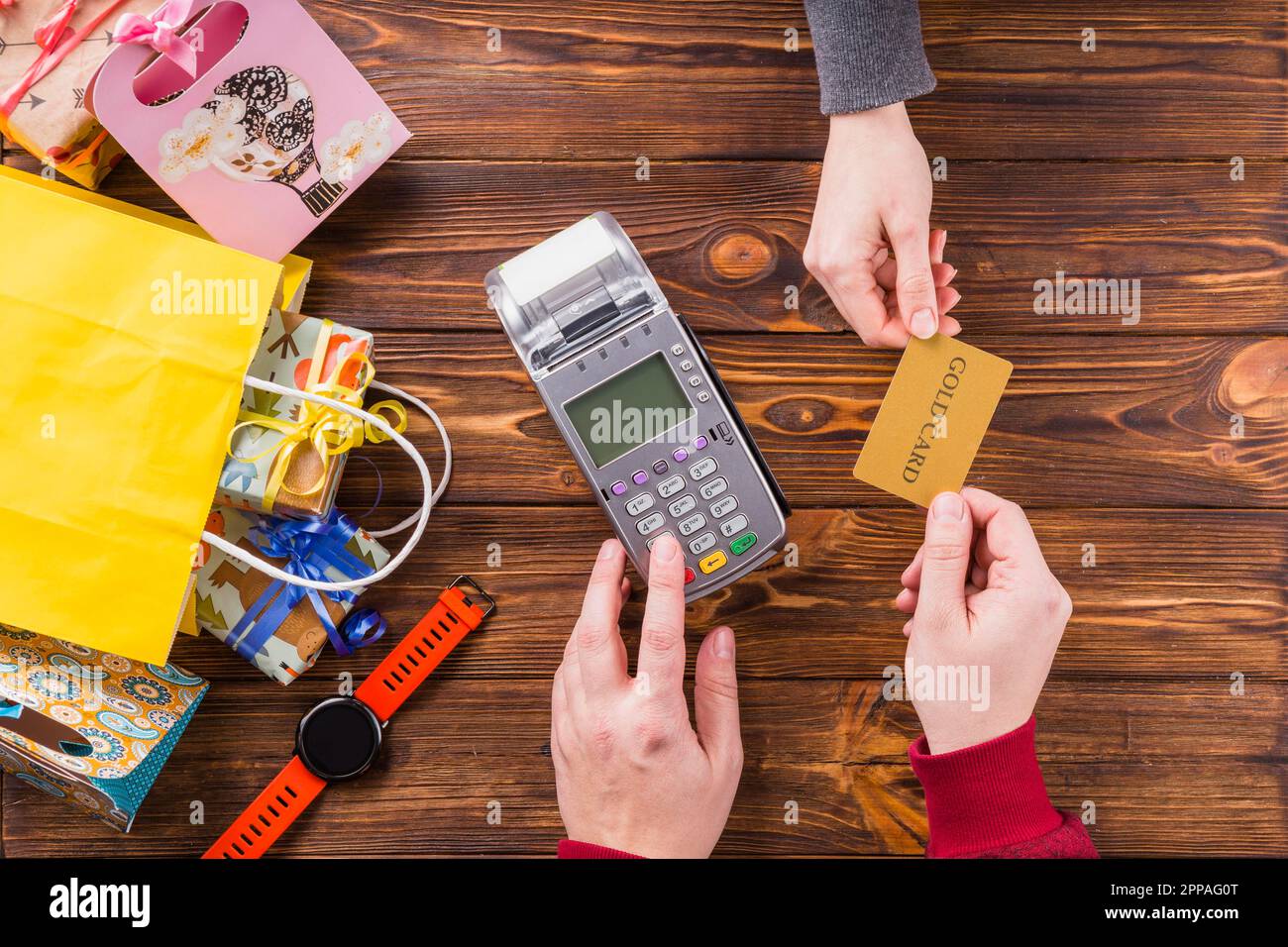 Woman giving bank card shop assistant payment Stock Photo - Alamy